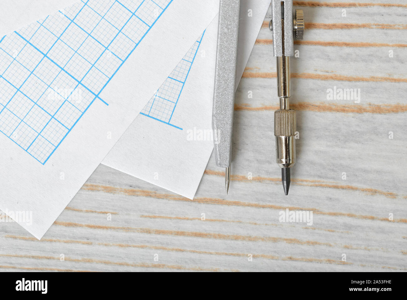 Close-up view of compass on graph paper Stock Photo - Alamy