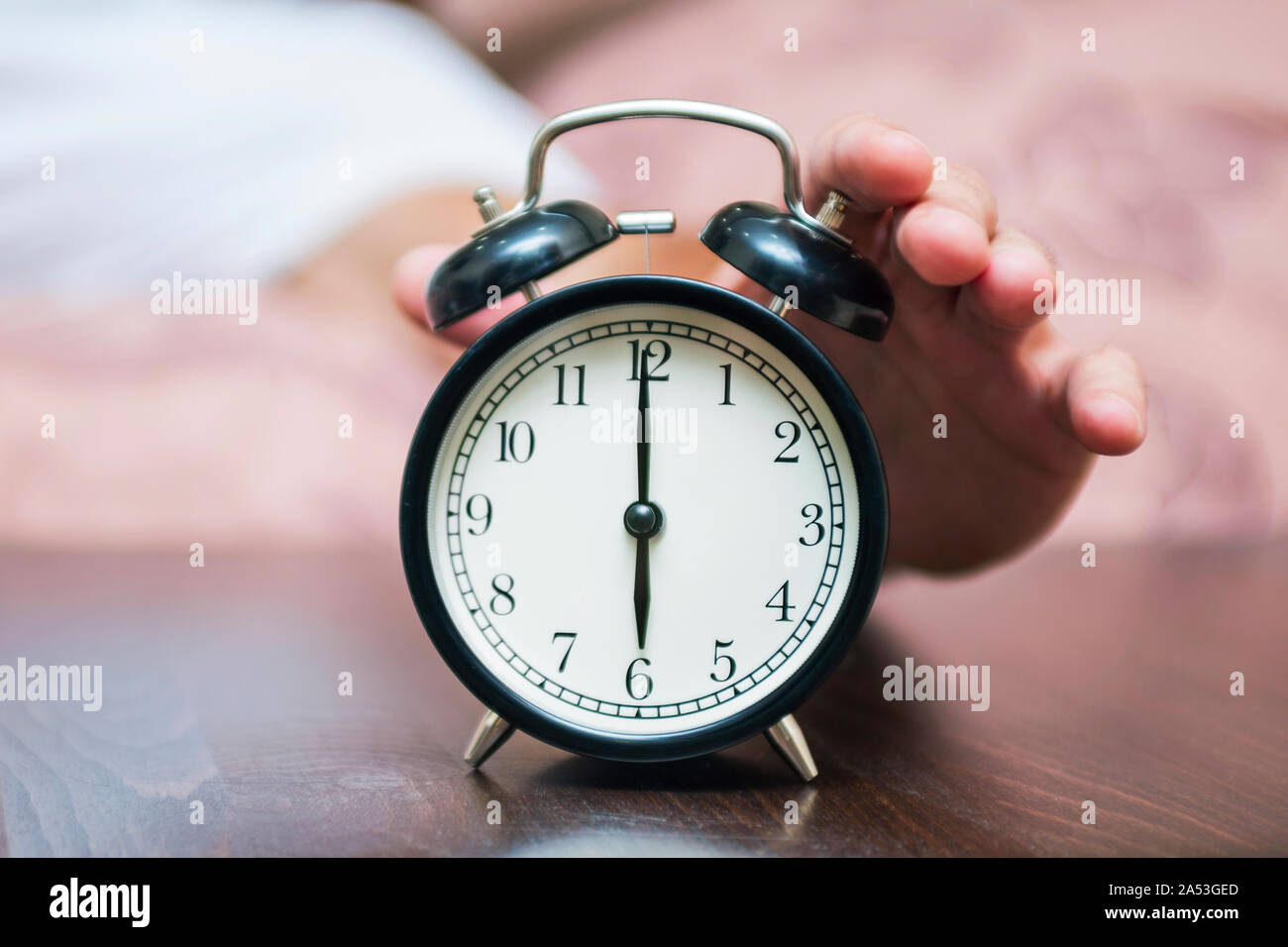 Hand turning off alarm clock hi-res stock photography and images - Alamy