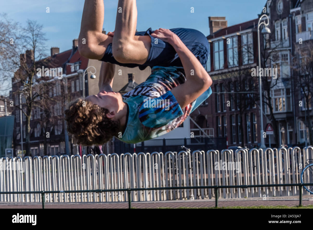 Amsterdam, Holland, February 25 2019 street flipping boy on the grass ...