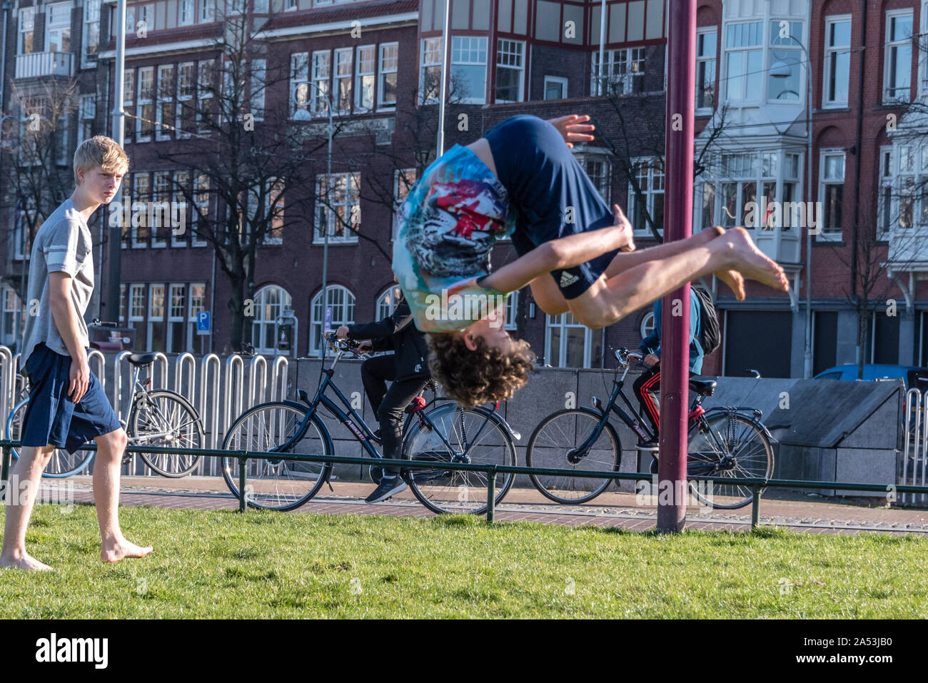 Amsterdam, Holland, February 25 2019 street flipping boy on the grass ...