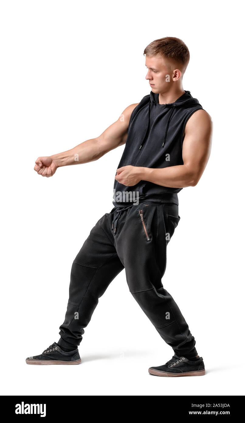 Side view of handsome muscled young man pulling something isolated on ...
