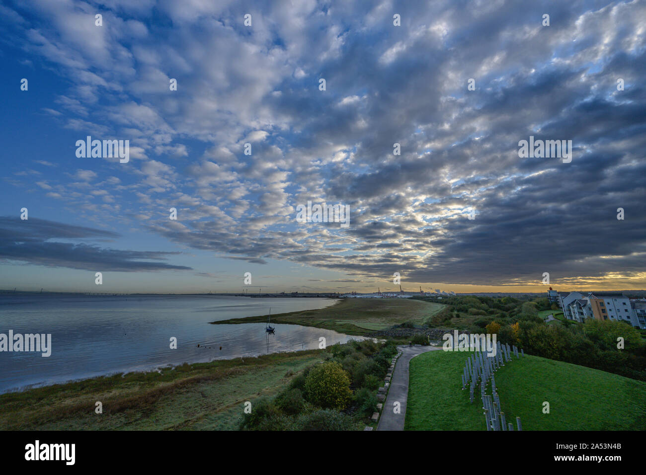 Scudding cumulus clouds race across an estuary causing high pressure ...