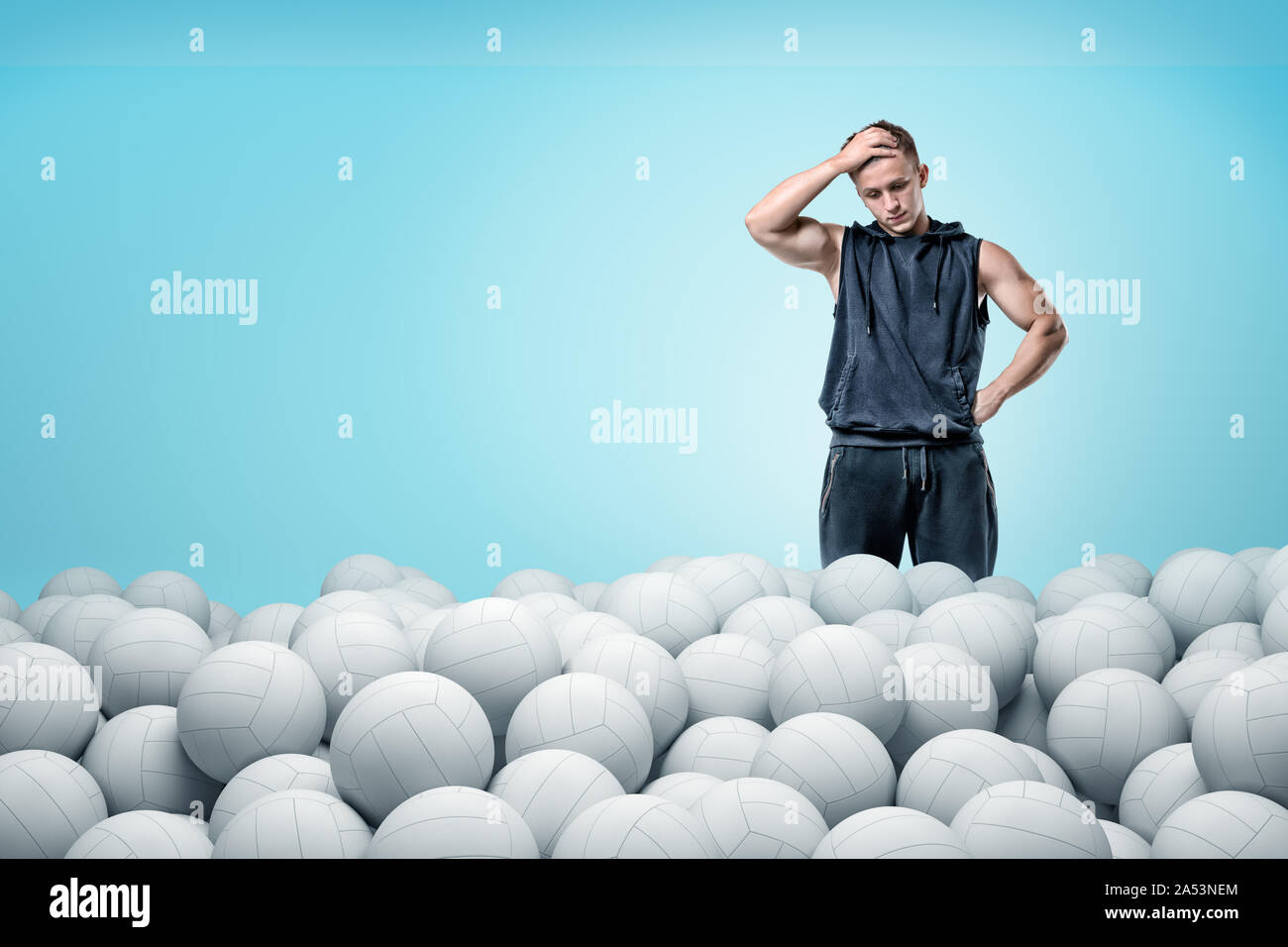 Sport man thinking over white volleyball balls on blue background Stock ...