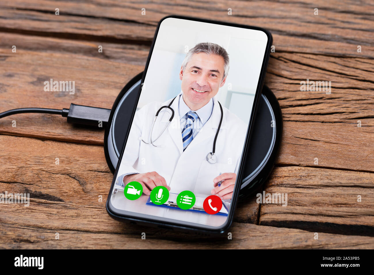 Mobile Phone Screen Showing Video Conference Of A Happy Male Doctor ...