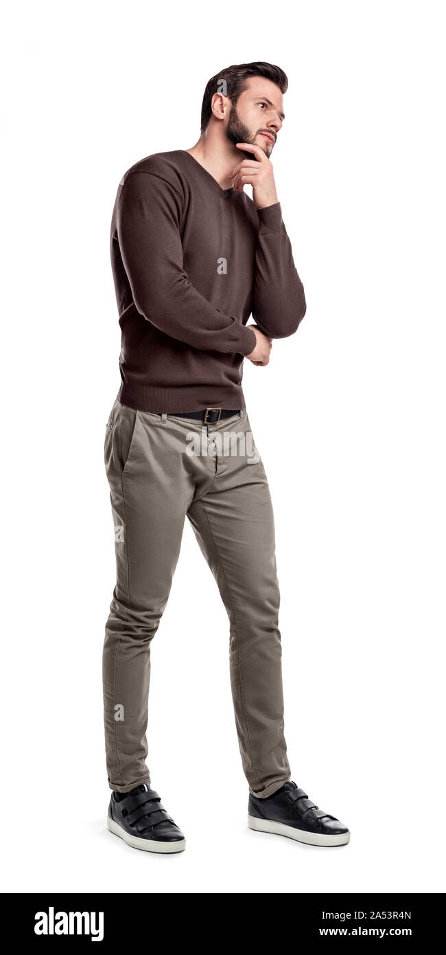 A bearded man in smart casual clothes stands in full height with one ...