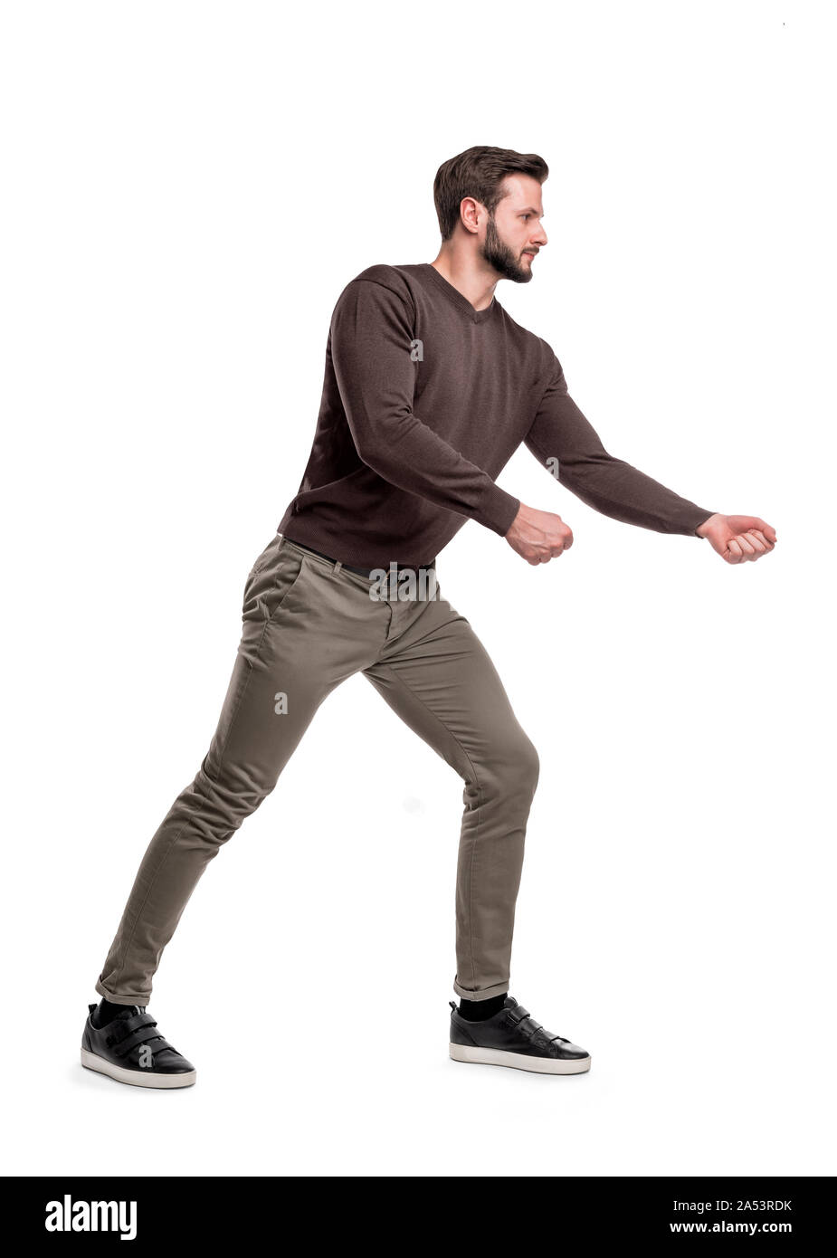 A bearded man a casual wear tries to pull an invisible rope with all ...
