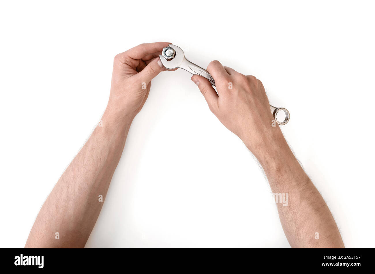 Close up view of a man's hands working with combination wrench ...