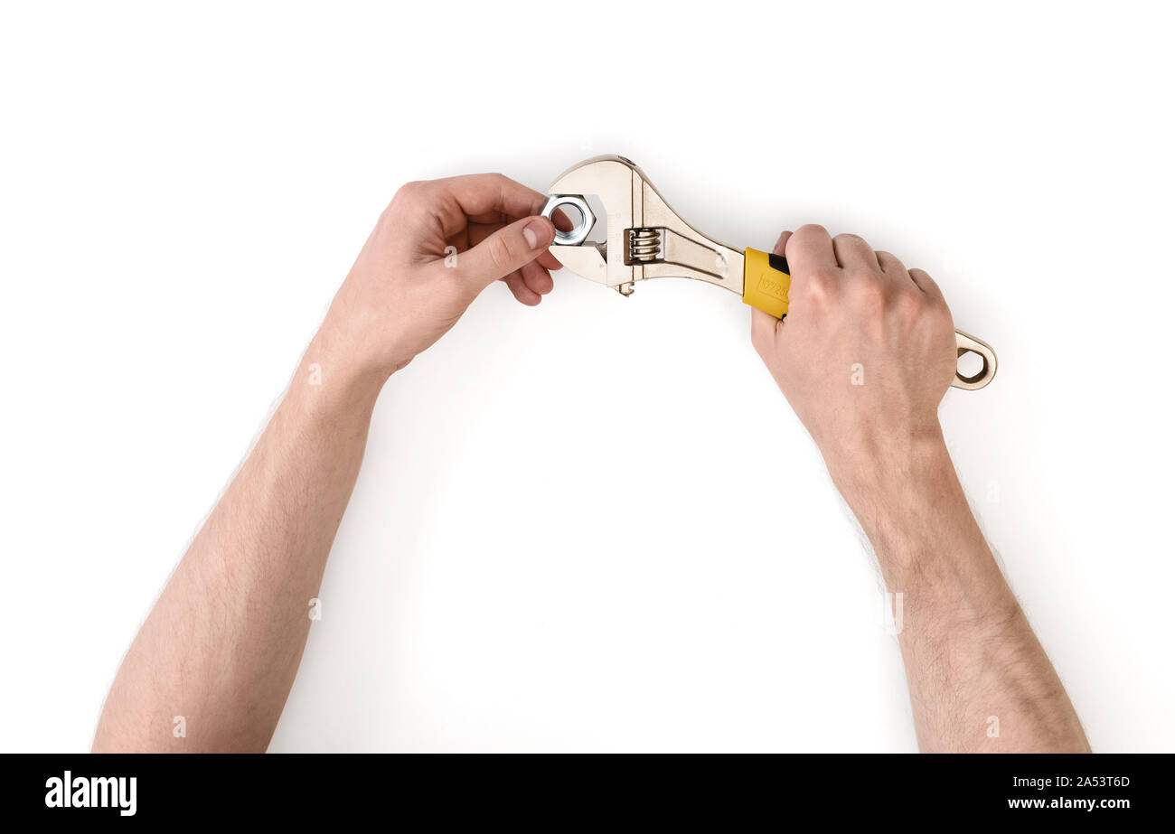 Close up view of a man's hands working with adjustable wrench, isolated ...