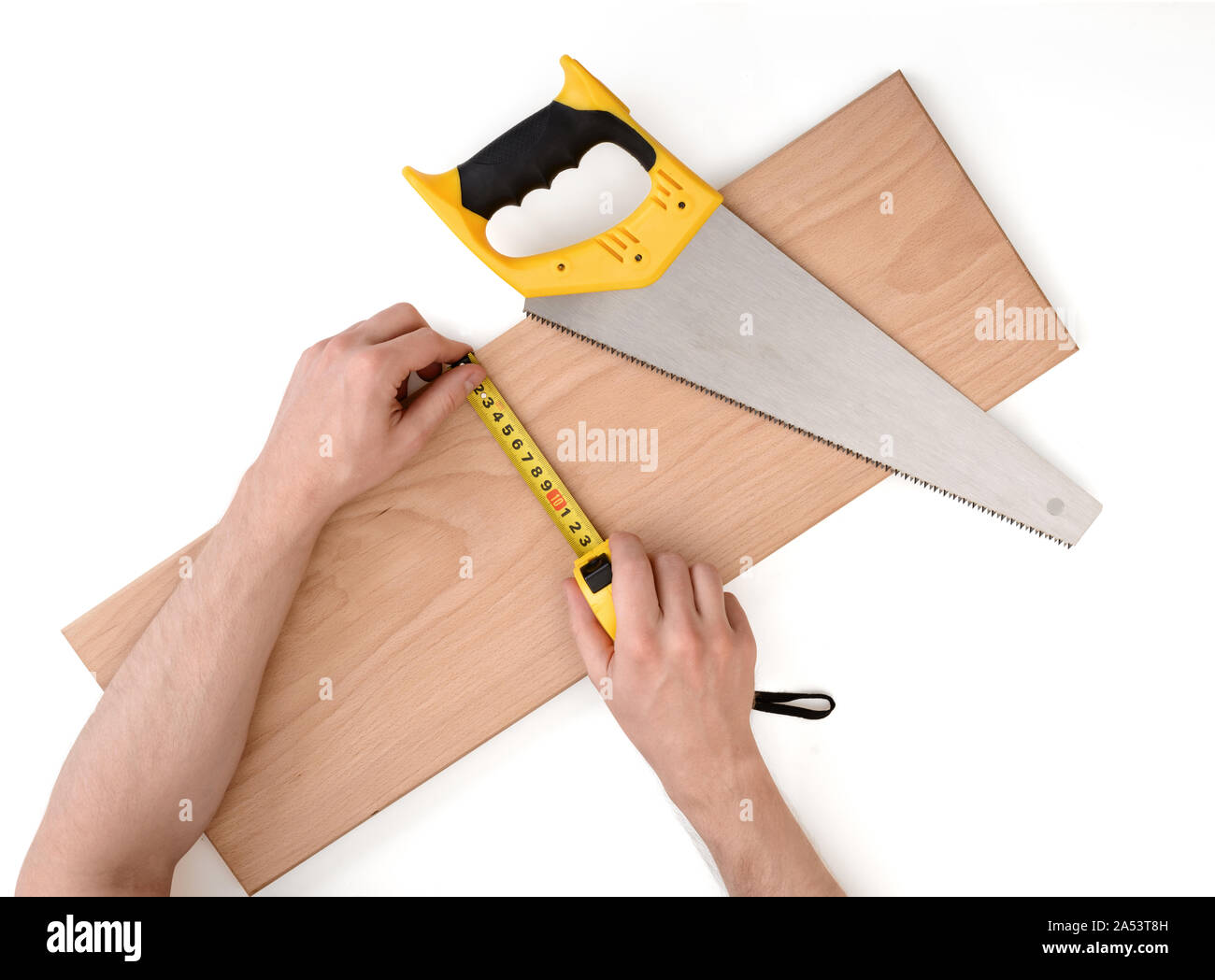 Close up view of a man's hands measuring wooden plank with tape line ...