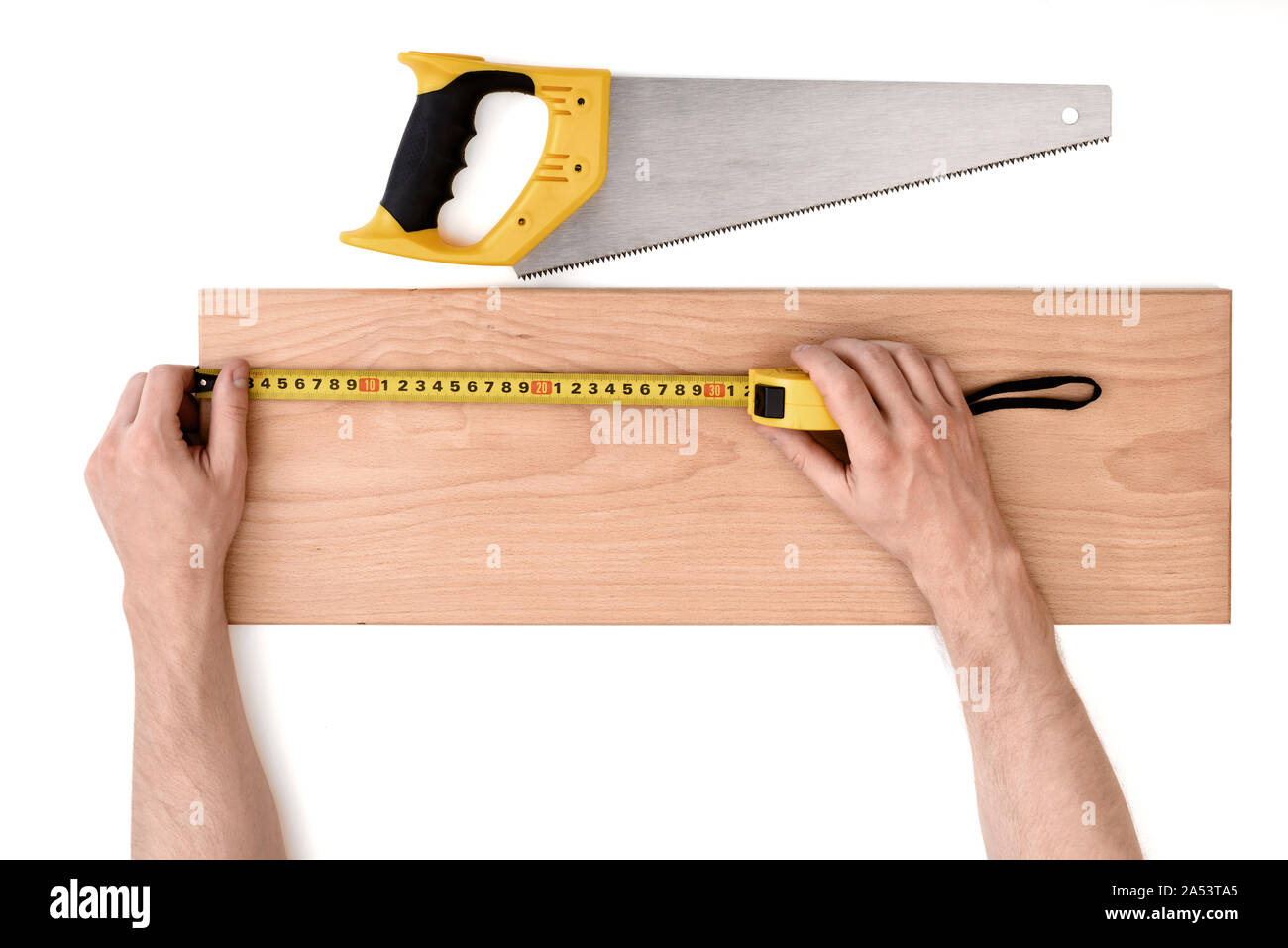 Close up view of a man's hands measuring wooden plank with tape line ...