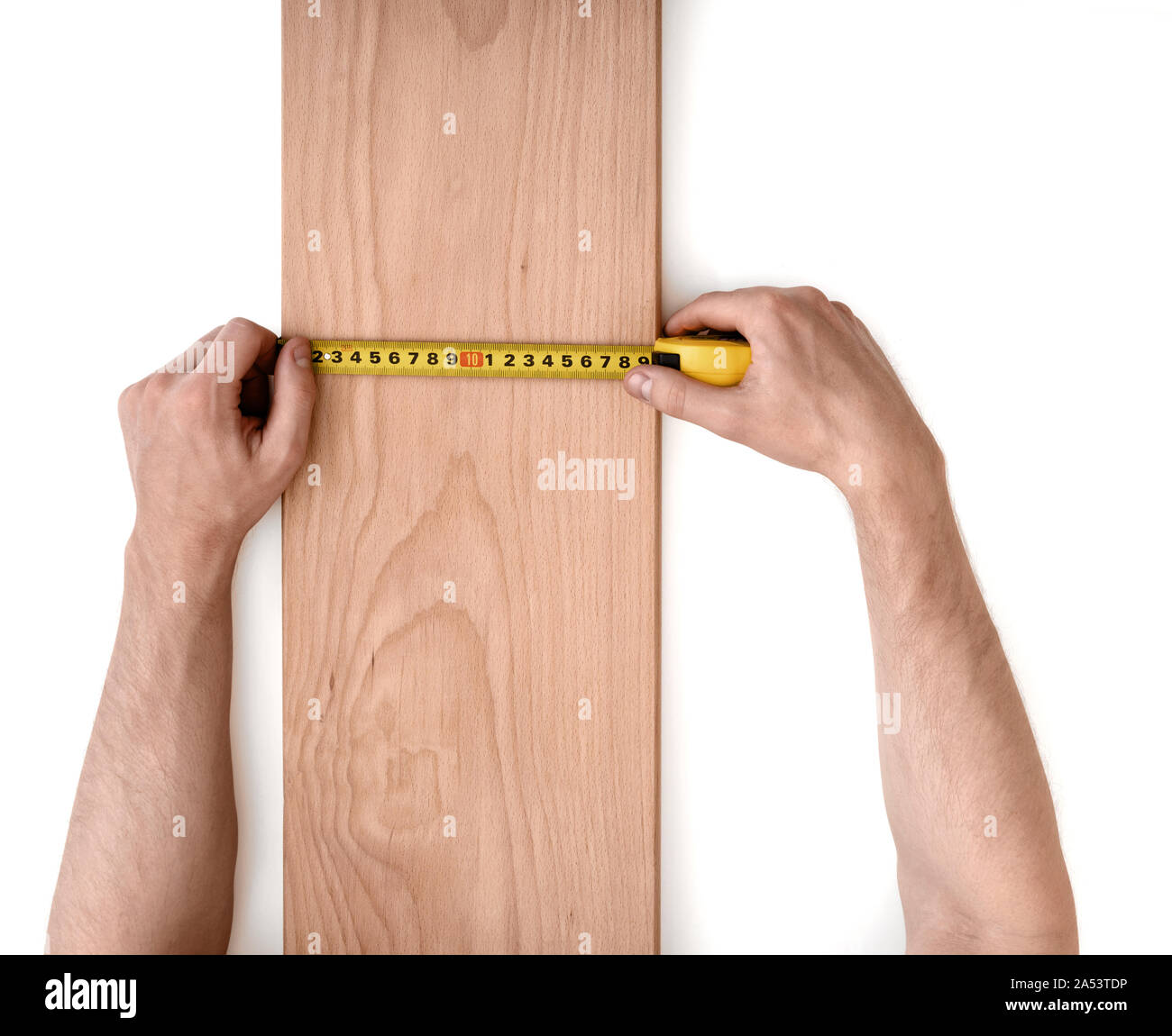 Man's hands measuring wooden plank with a tape line isolated on white ...