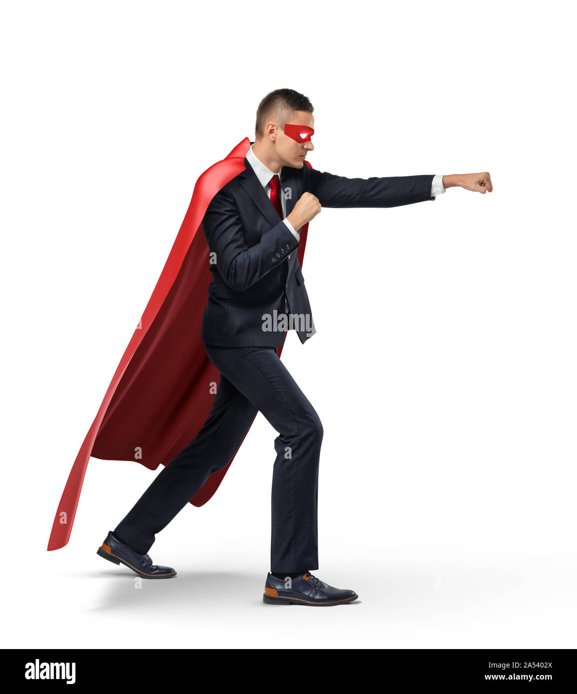 A businessman in a superhero red cape and a mask standing in side view ...