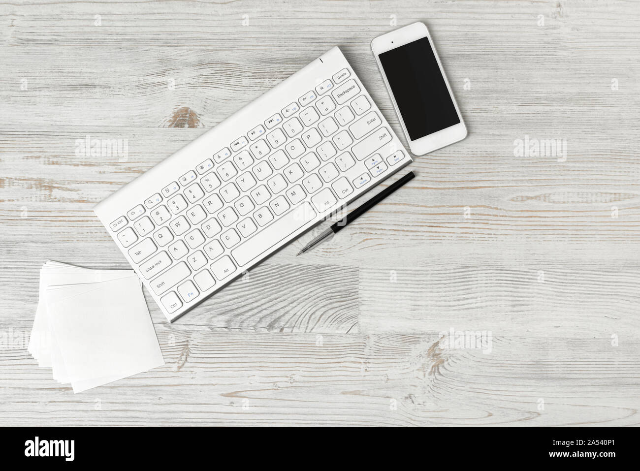 Workstation at a white rustic wooden desk Stock Photo - Alamy