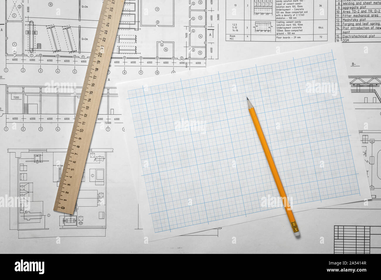 Open blueprints on wooden table background with a pencil and a ruler ...