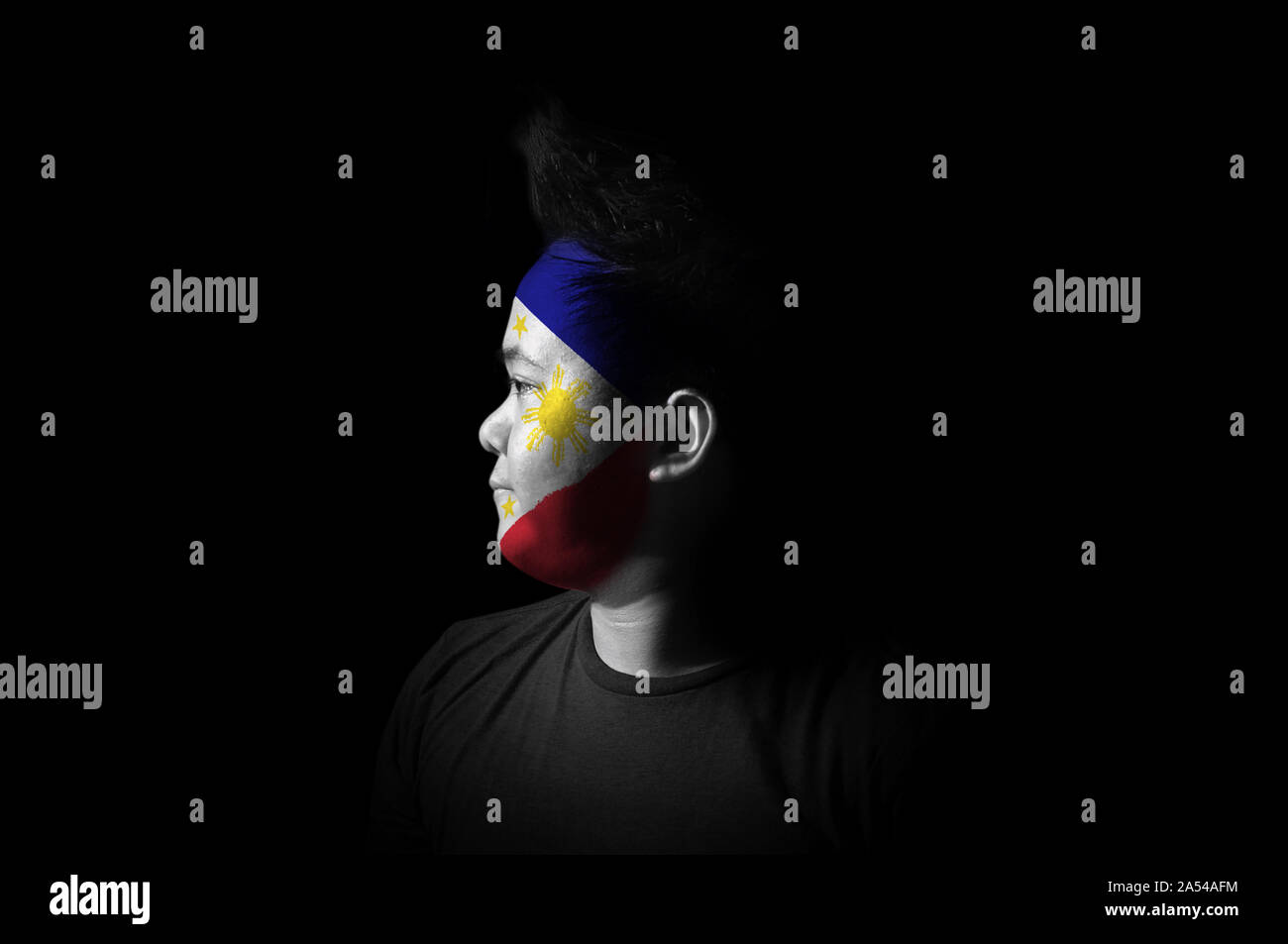 Dramatic scene of a Filipino young man face painted in Philippine flag ...