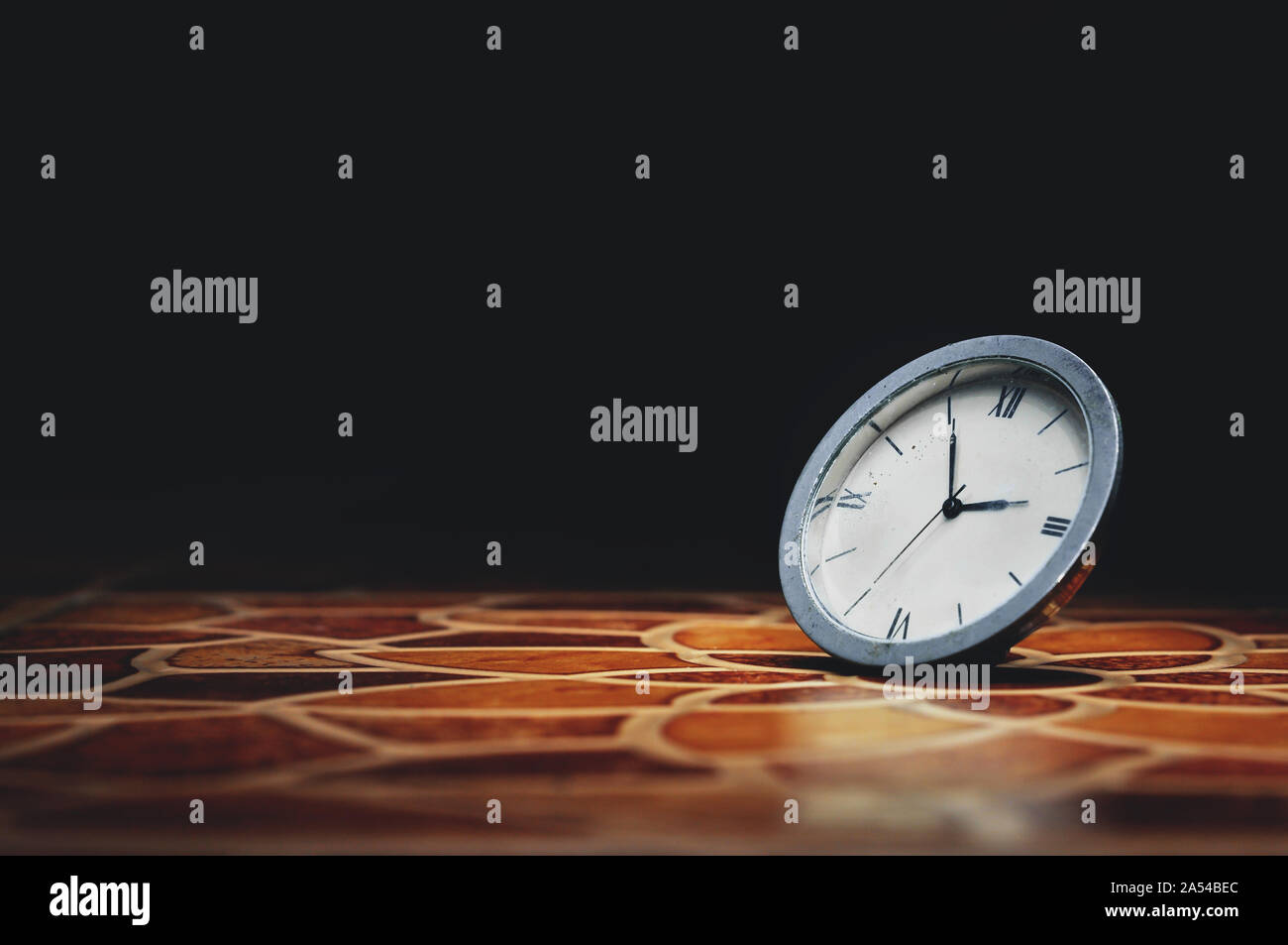 Broken vintage clock drop on a floor. Dramatic time under the spotlight ...