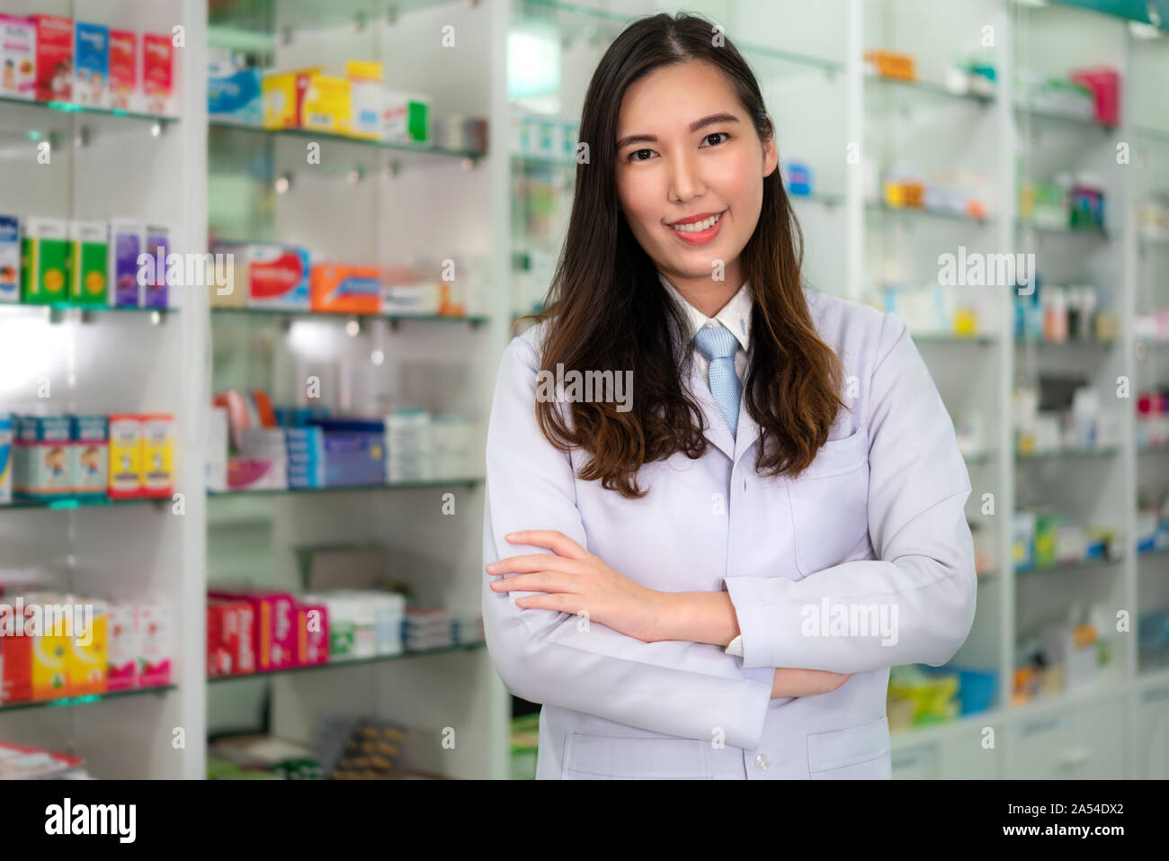 Confident Asian young female pharmacist with a lovely friendly smile ...