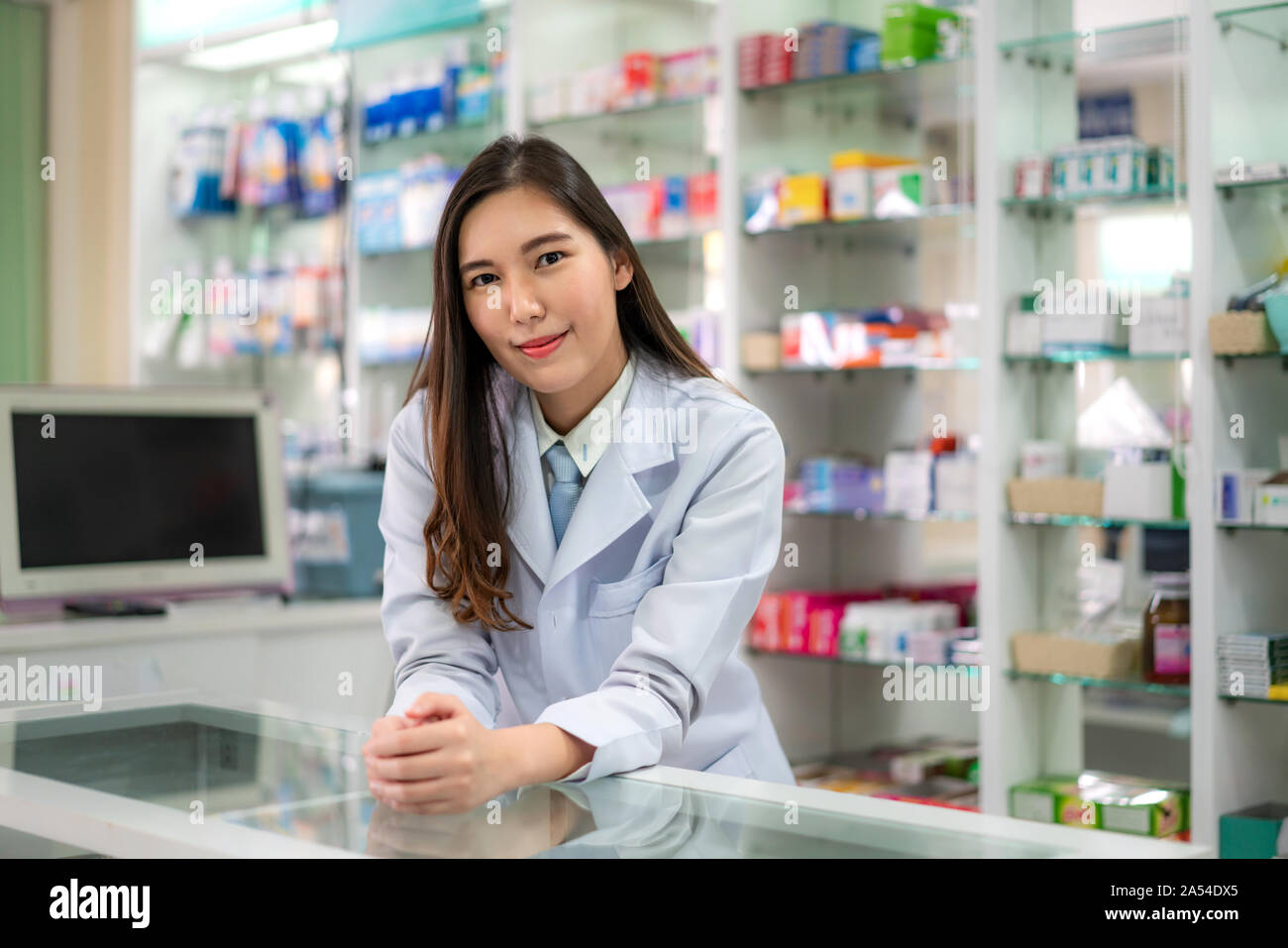 Confident Asian young female pharmacist with a lovely friendly smile ...