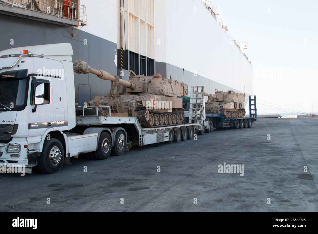 Two M109A Paladin’s pull on to the dock prepared for loading operation ...
