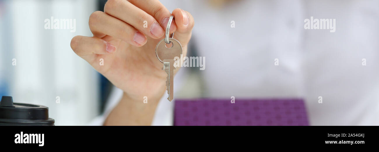 Female hand holds the key to the lock in the hand Stock Photo - Alamy