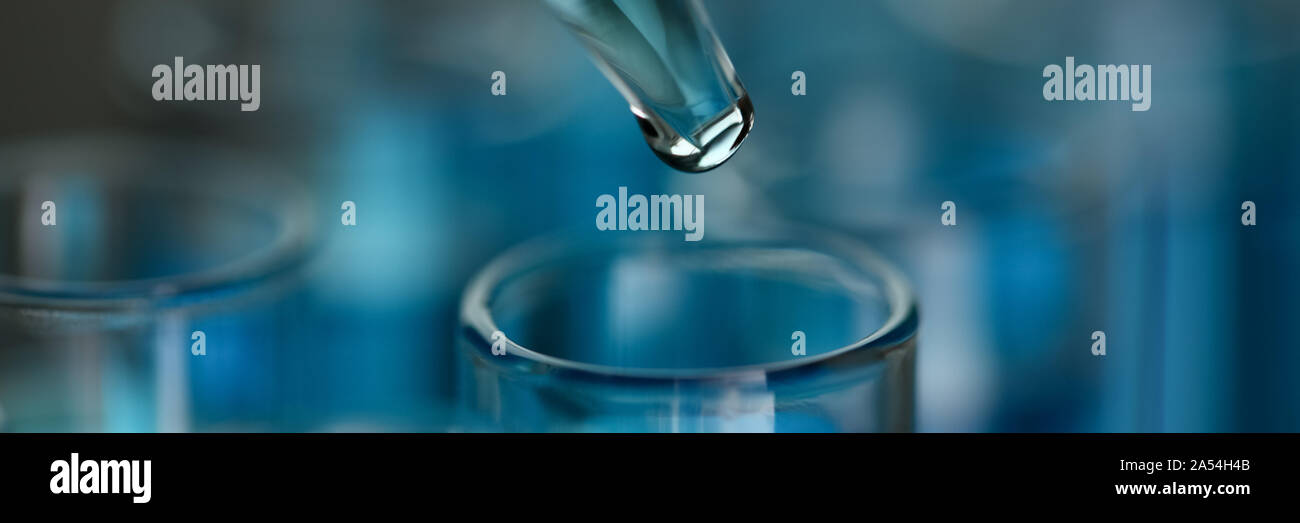Test tube of glass overflows liquid solution potassium Stock Photo - Alamy