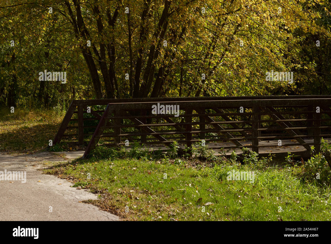 Scenic landscape of a rustic bridge over a river in a rural woodland ...