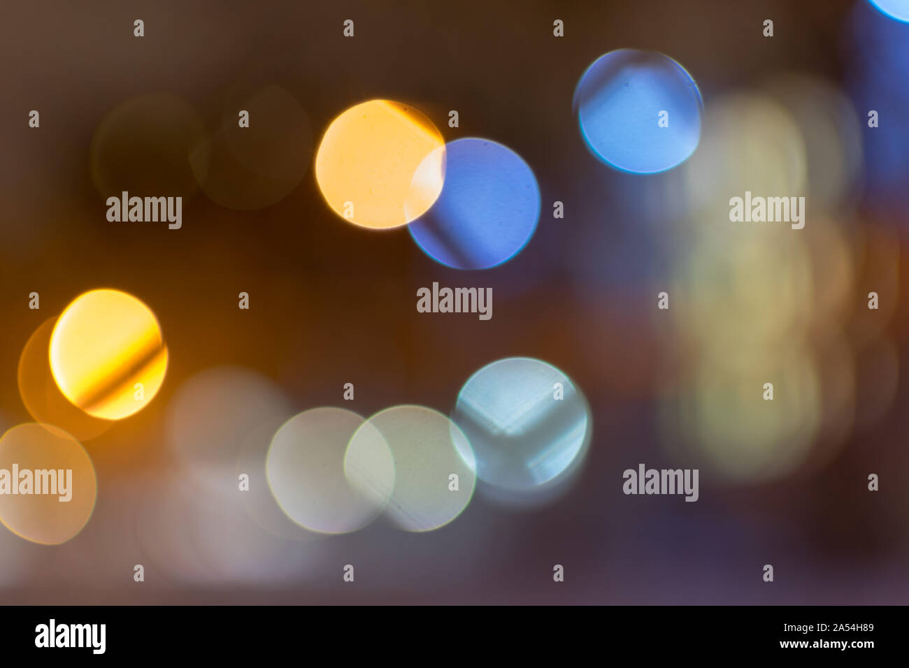 Abstract multicolored bokeh balls, floating across a dark background ...