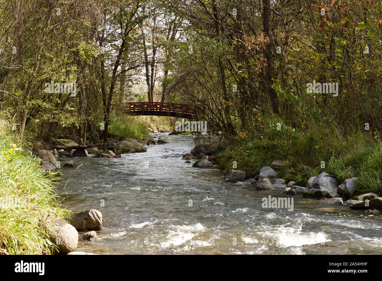 Scenic landscape of a rustic bridge over a river in a rural woodland ...