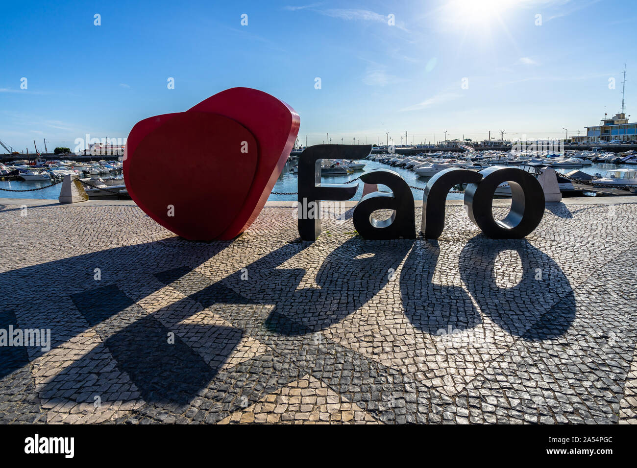 Love and hear sign at Faro waterfront with boat moored at the marina ...