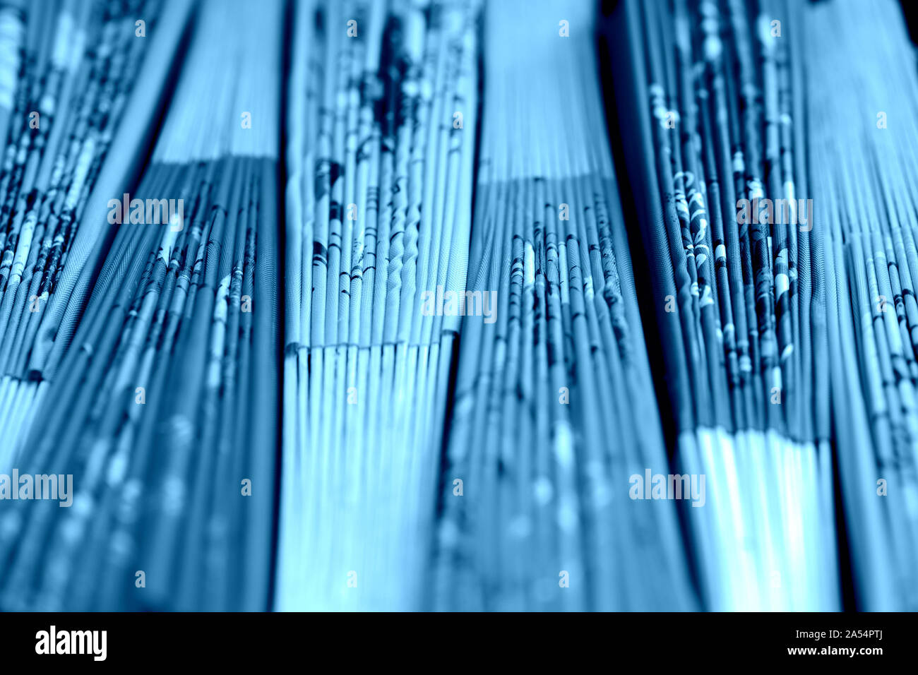 Folded Vietnamese fans on a dark background close-up. Blue color toned ...