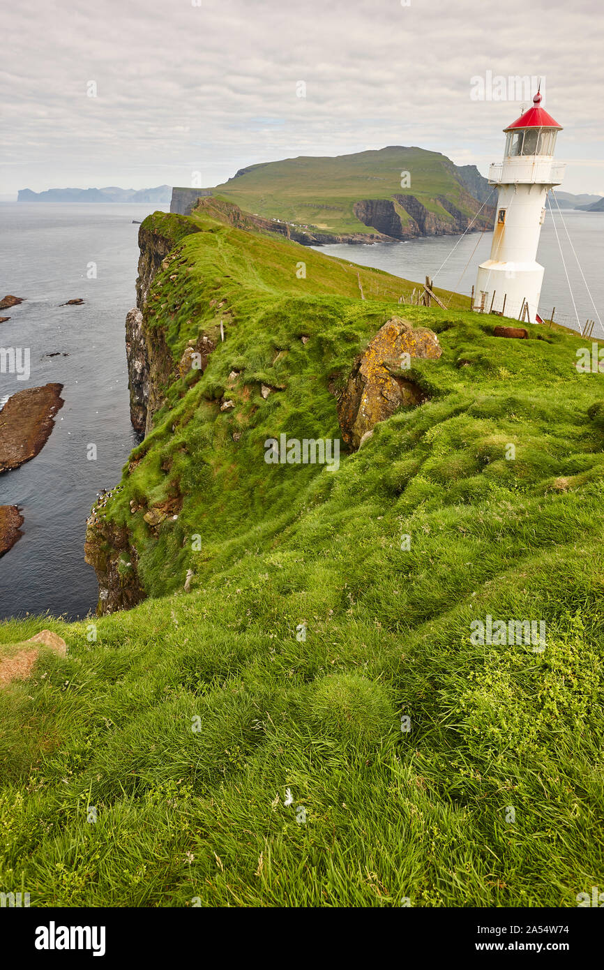 Mykines lighthouse and cliffs on Faroe islands. Hiking landmark ...
