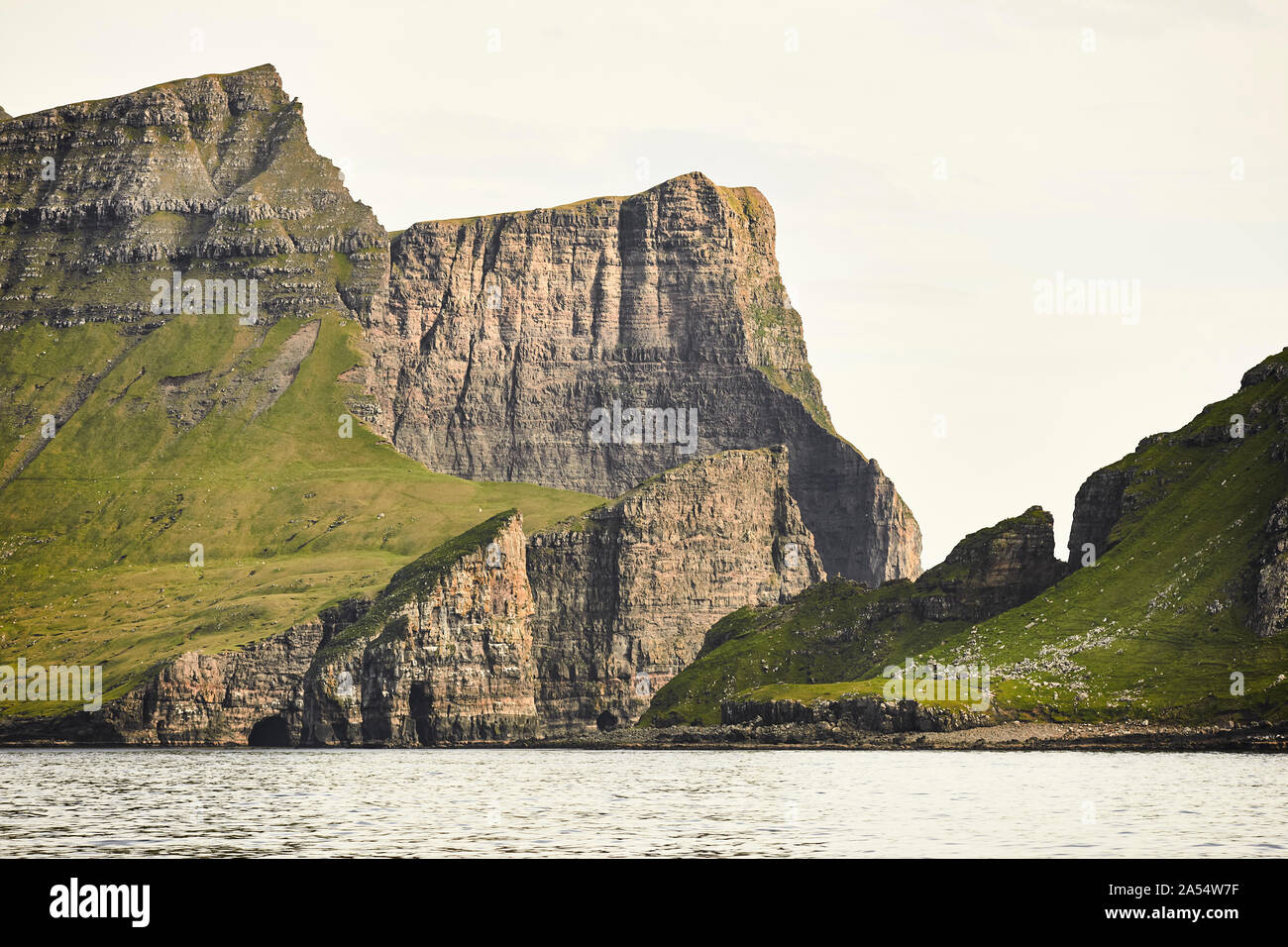 Faroe islands cliffs on atlantic ocean at sunset. Stunning view Stock ...