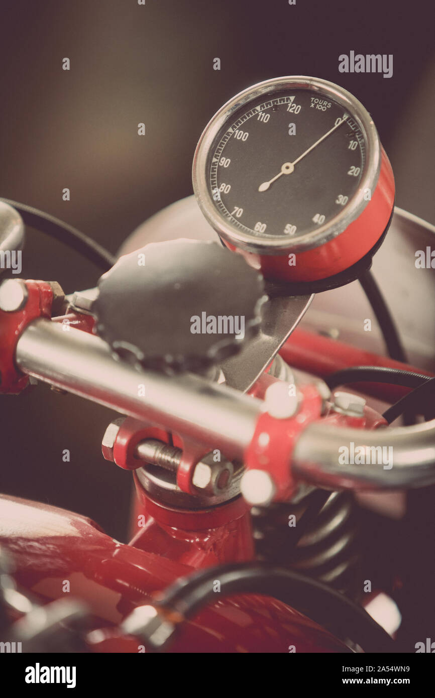 Close up vertical image of the tachmeter gauge of a vintage motorcycle ...
