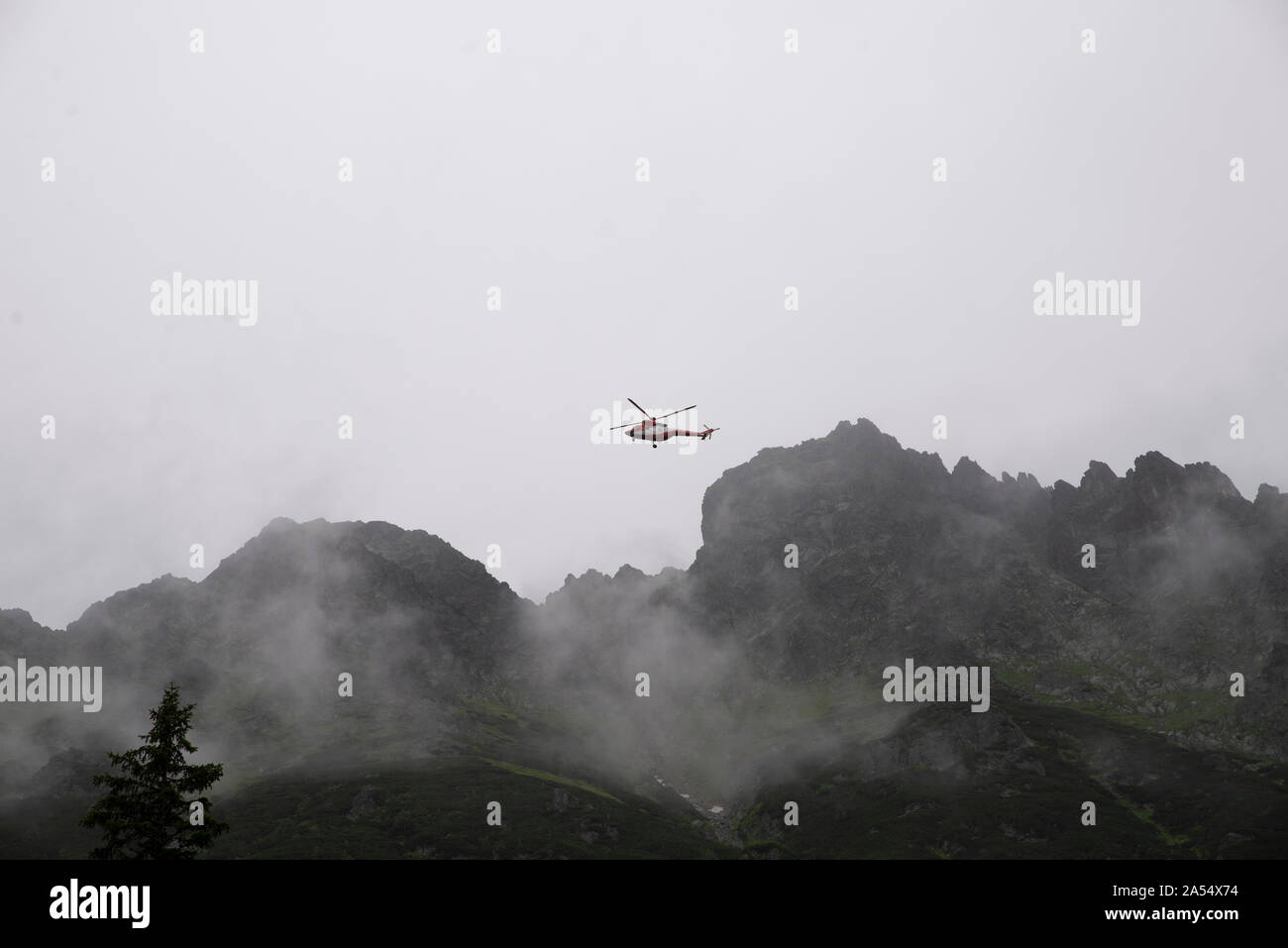 rescue helicopter in the mountains, heavy fog, Tatra Stock Photo - Alamy