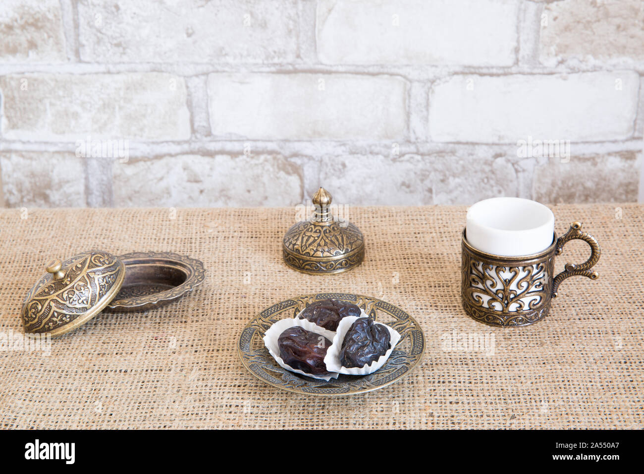 Turkish coffee with dried dates, brick wall background Stock Photo - Alamy