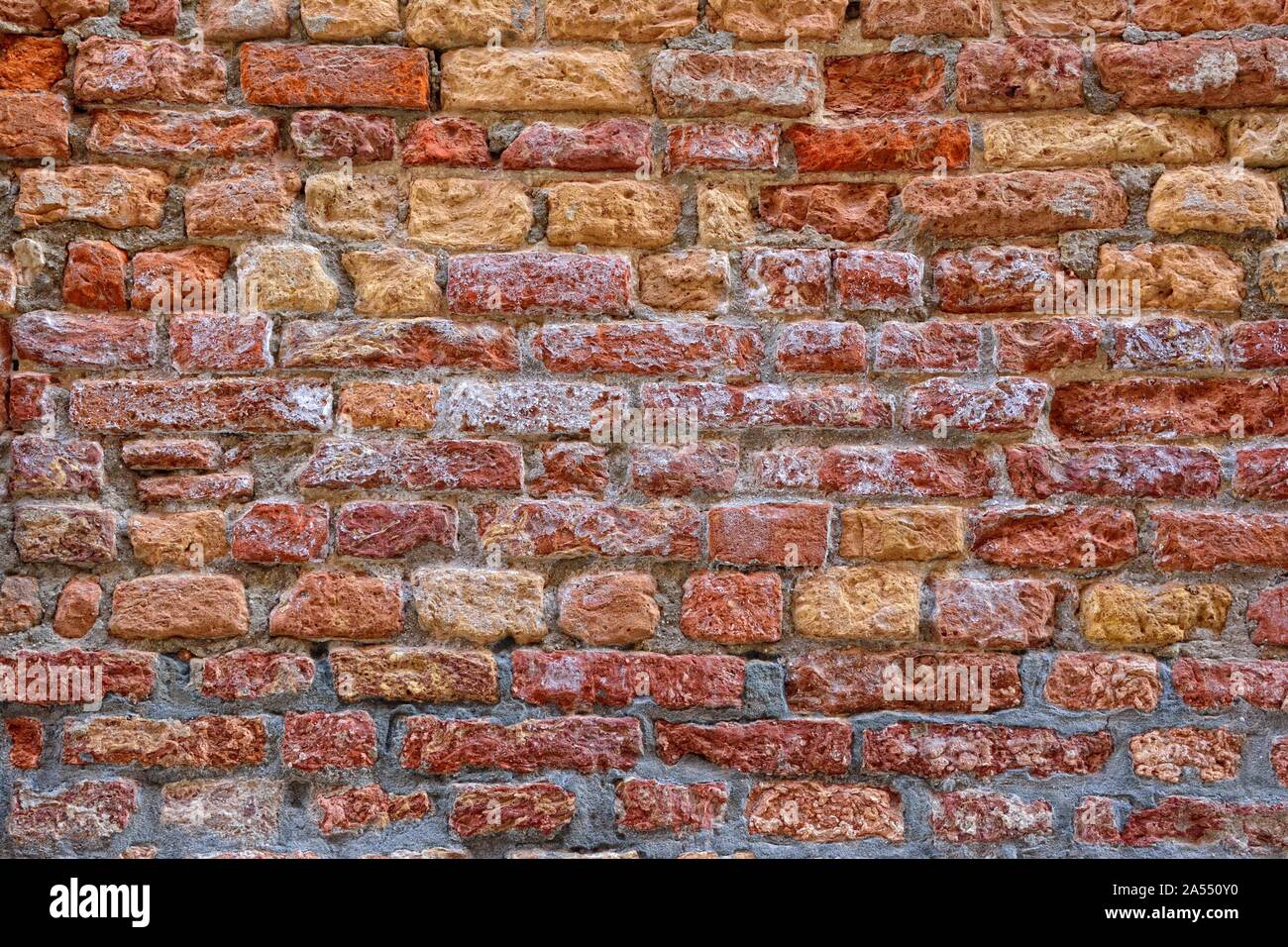 Red brick wall with saltpeter and moisture in Venice Stock Photo - Alamy