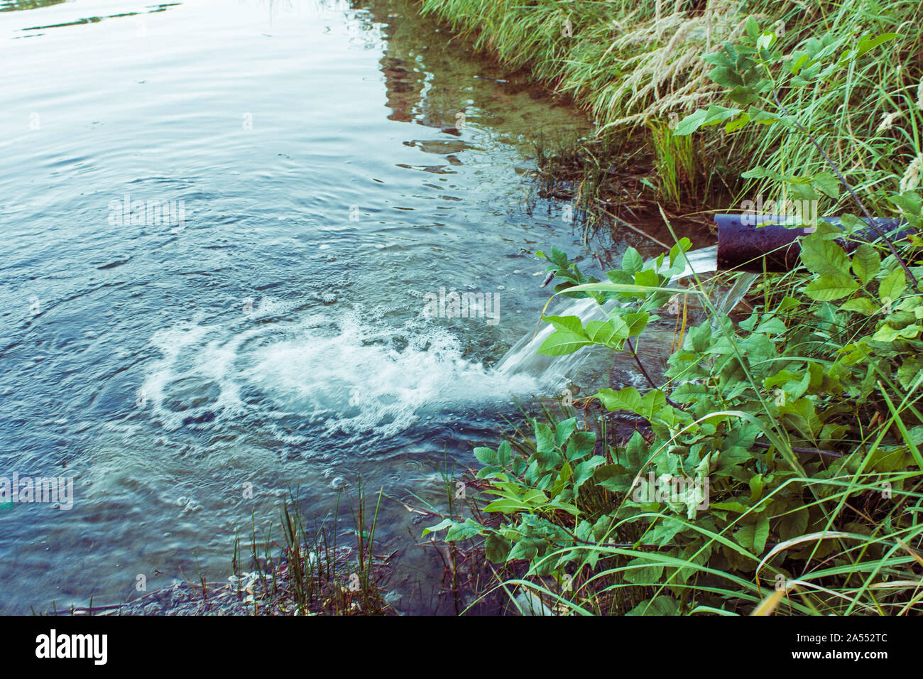 Sewage flows into the lake, river. Water flows from the pipes ...