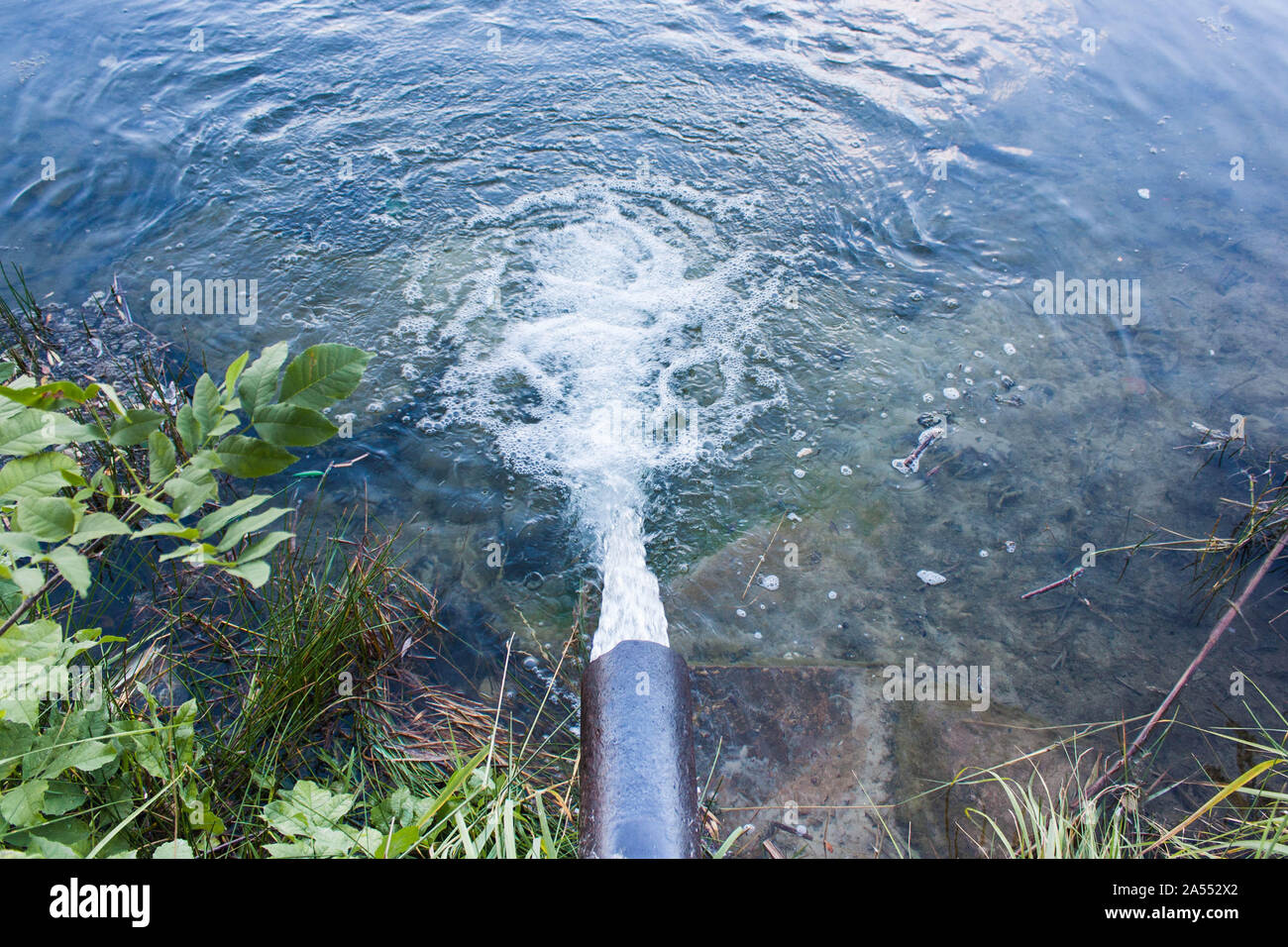 Sewage flows into the lake, river. Water flows from the pipes ...