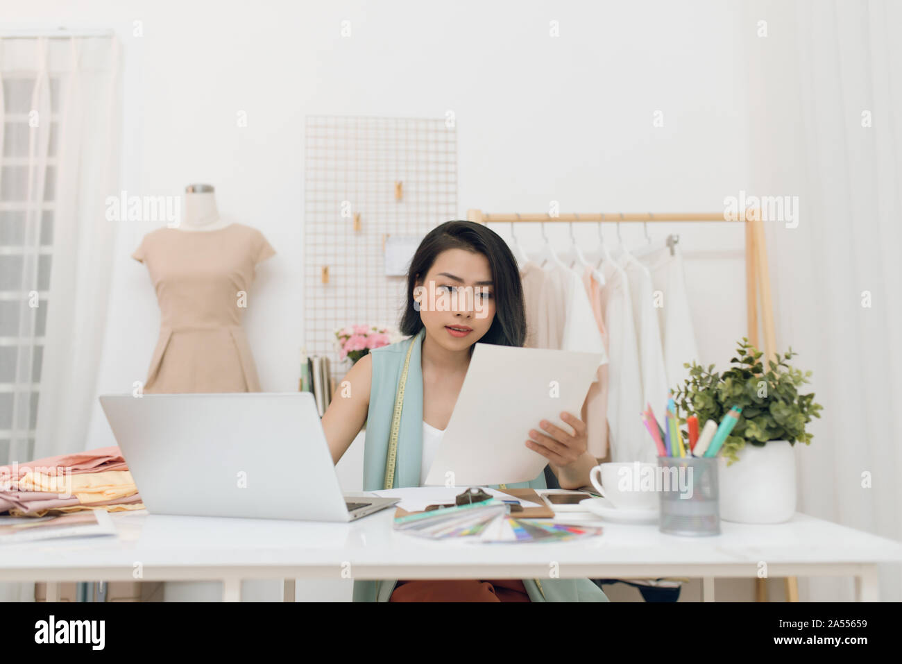 A business woman / Asian fashion designer working at her office ...