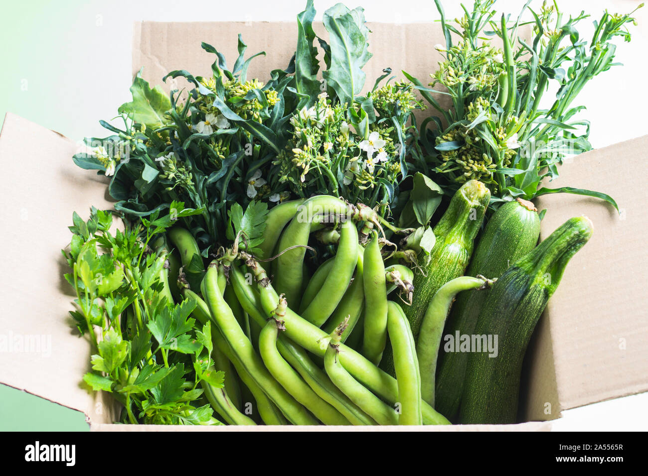 Green vegetables and herbs in cardboard box. Healthy organic food ...