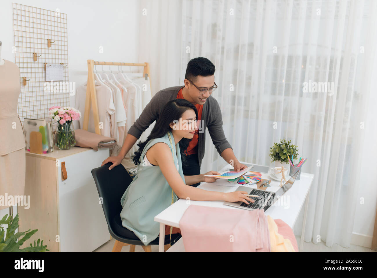 Young female and male fashion designers team talking about new ...