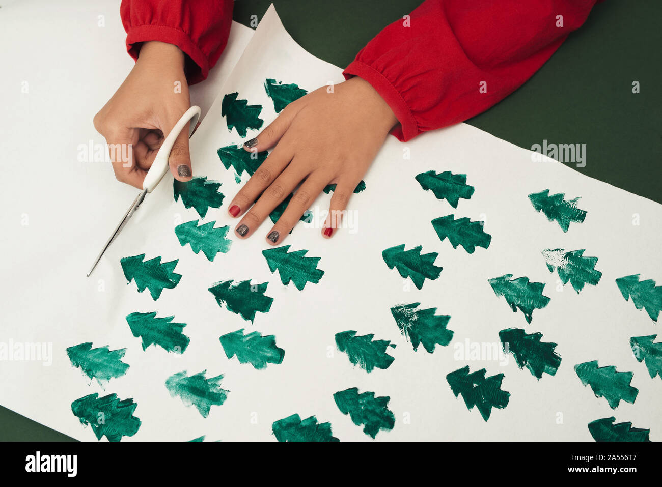 Woman cutting kraft paper and making envelopes at workshop, studio ...