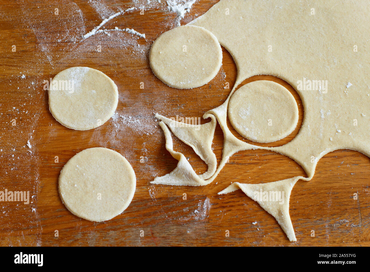 Cutting dough into small circles for dumplings top view Stock Photo - Alamy