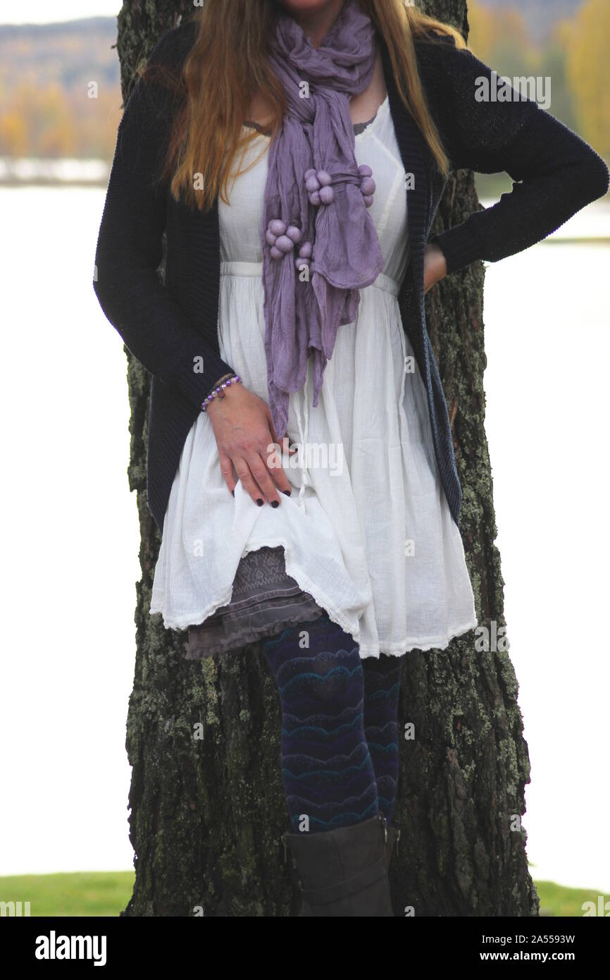 Woman leaning against a tree Stock Photo - Alamy