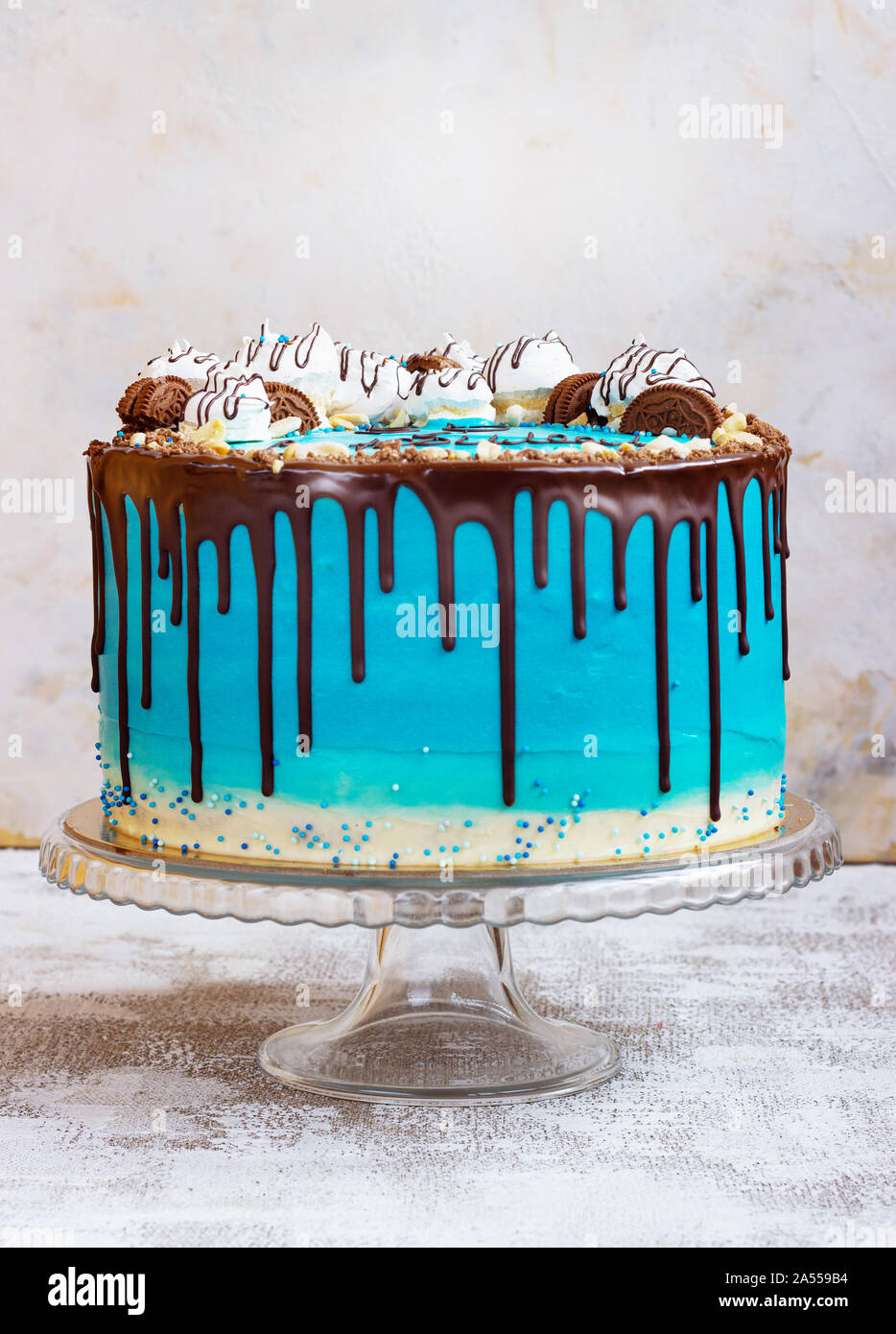 Blue cream cake in a marine style on a light backgroundwith chocolate ...