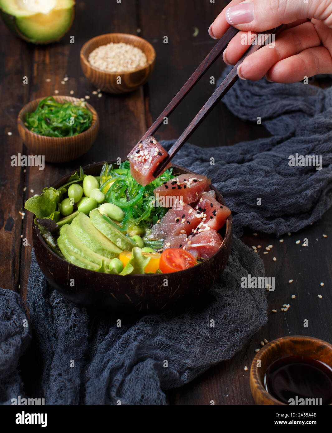 Girl eating hawaiian tuna poke salad in the bowl top view Stock Photo ...