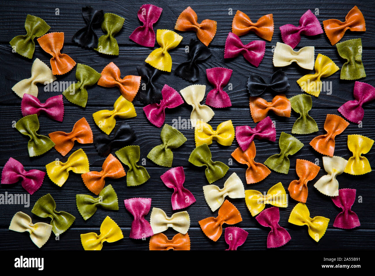 Assortment of colorful farfalle or farfalline on wooden rustic black ...