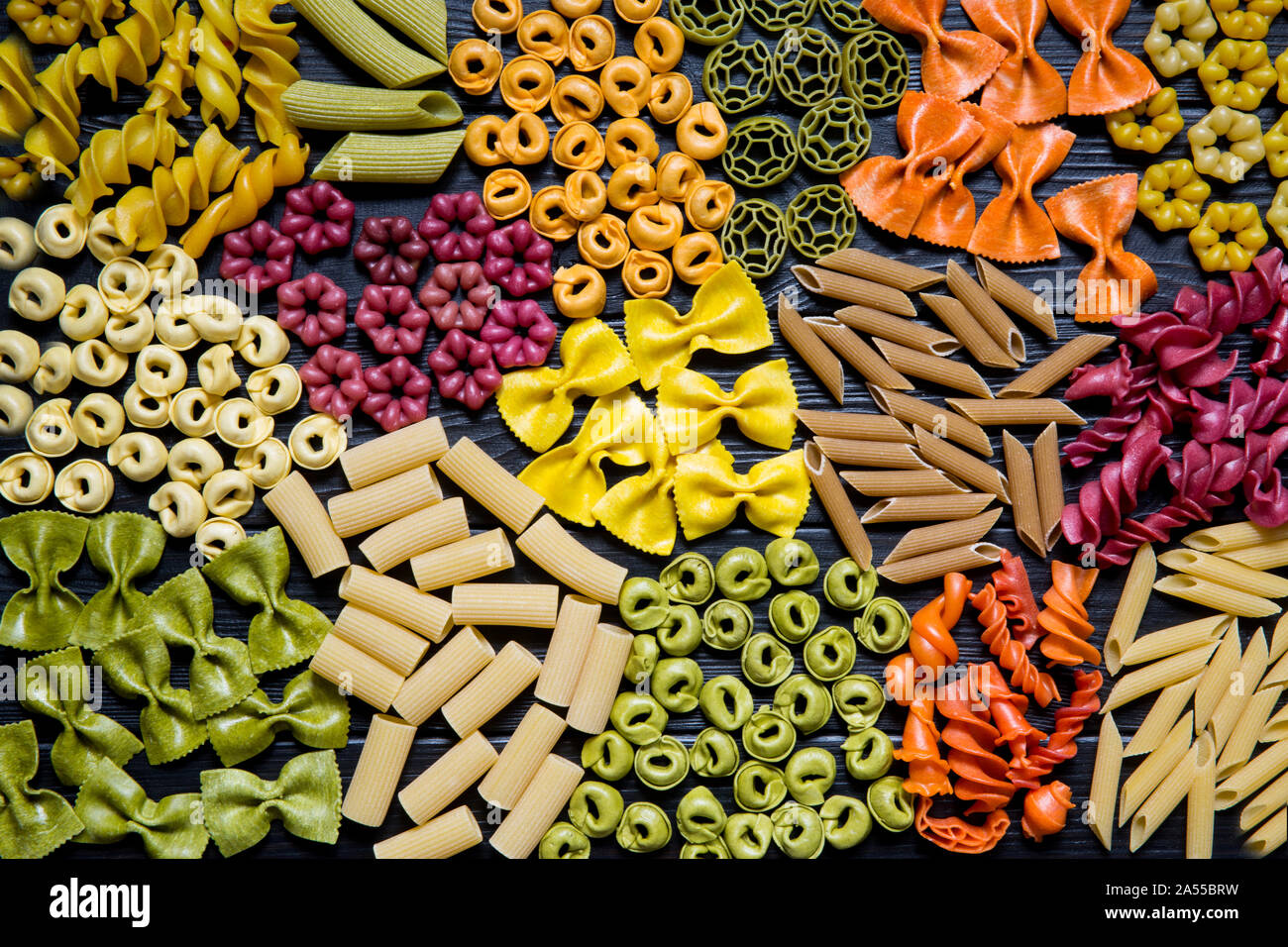 Different kinds of pasta on black wooden background, italian cuisine ...