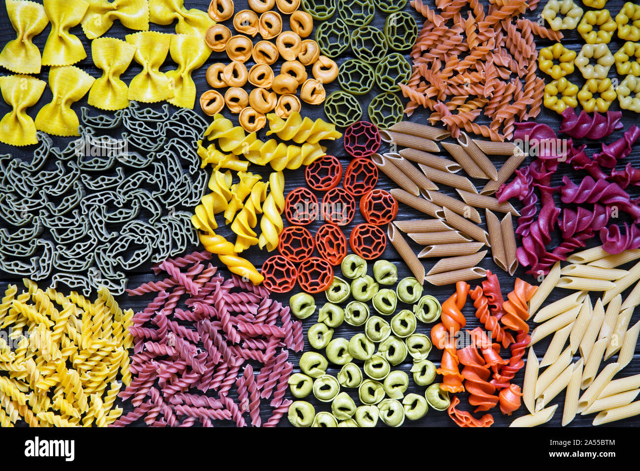 Assortment of pasta. Different kinds of macaroni. Colorful, red, green ...