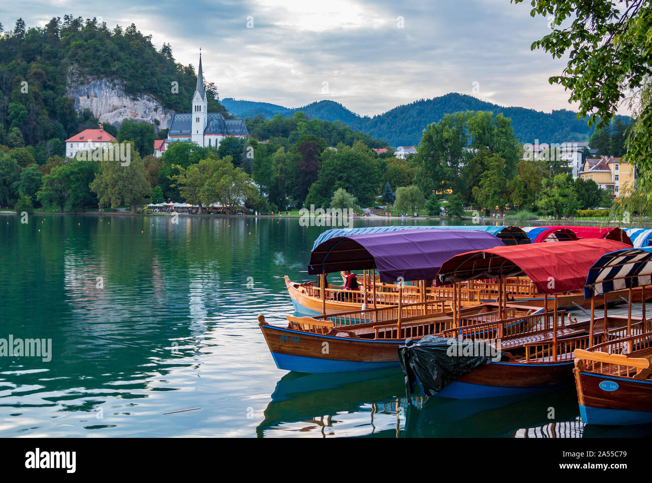 Traditional Wooden pletna Boats on Lake Bled with St Mary's Church of ...